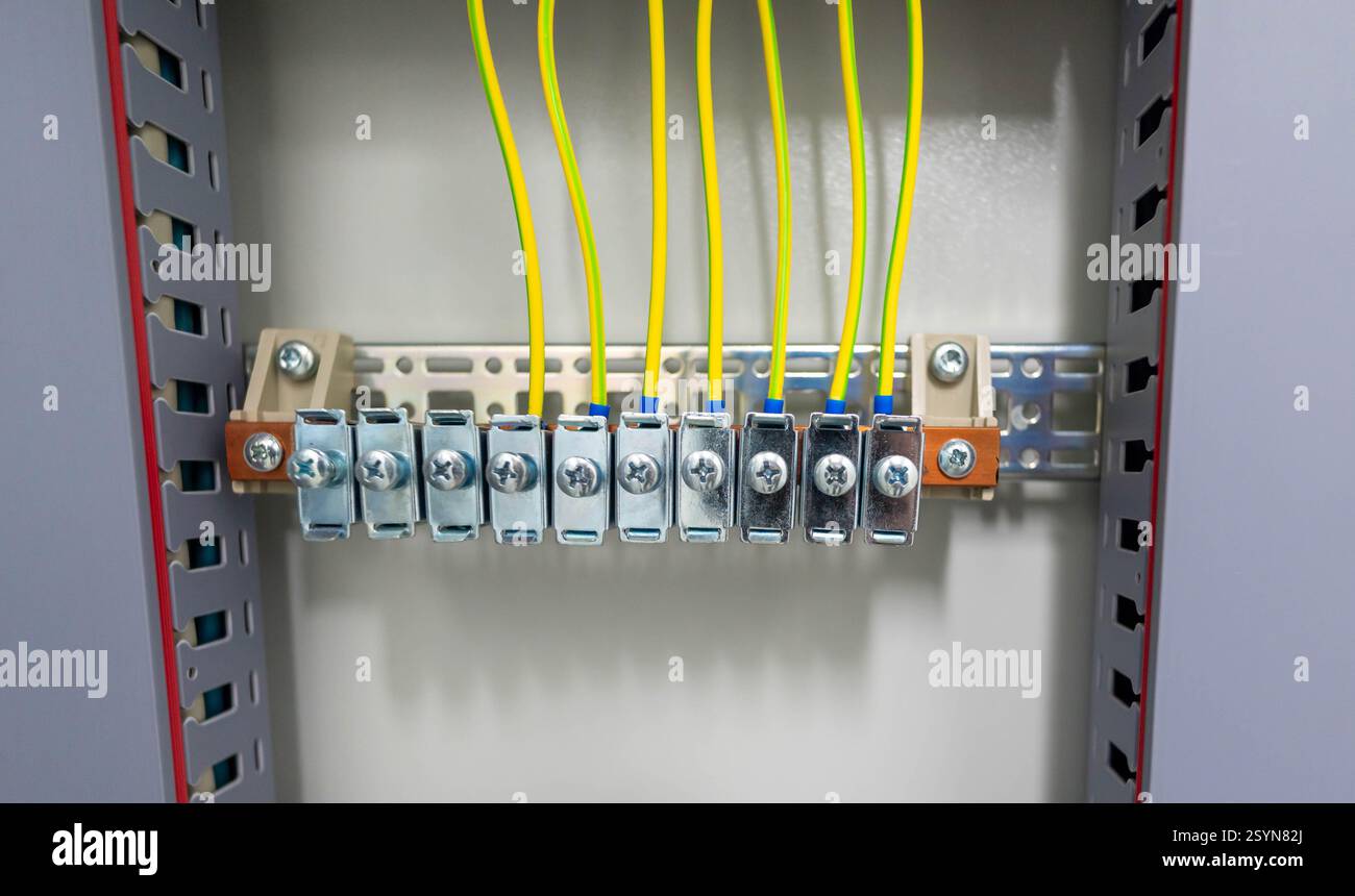 Grounding terminal block with connected yellow wires inside an ...