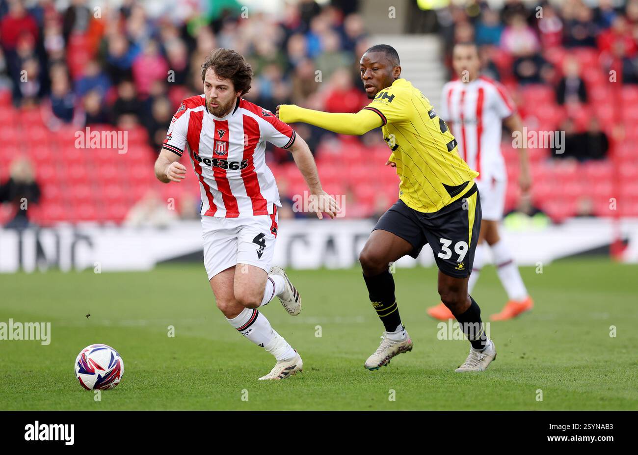 Stoke City's Ben Pearson (left) and Watford's Edo Kayembe battle for the ball during the Sky Bet ...