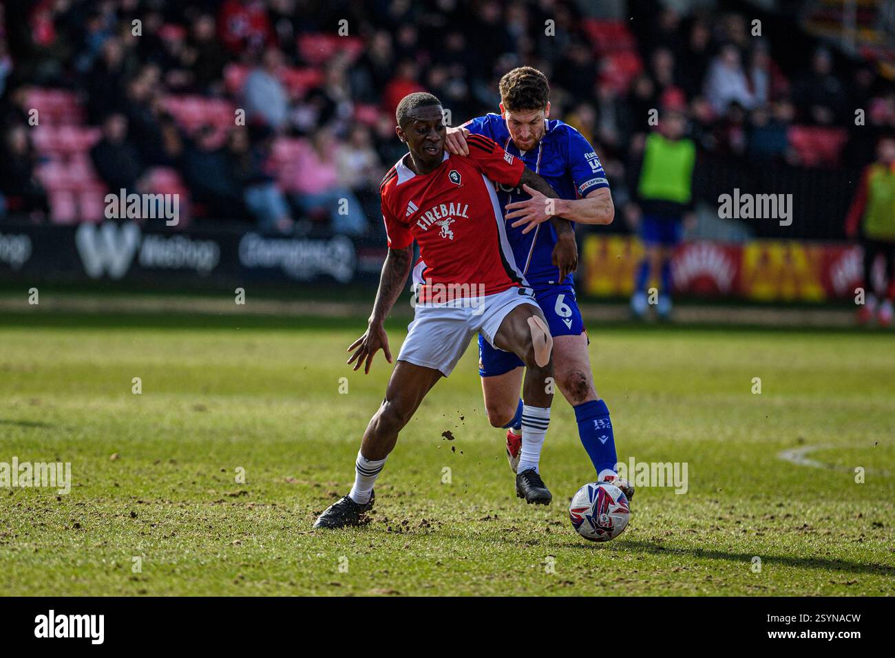 Tyrese Fornah of Salford City FC is tackled by Bradford City FC's ...