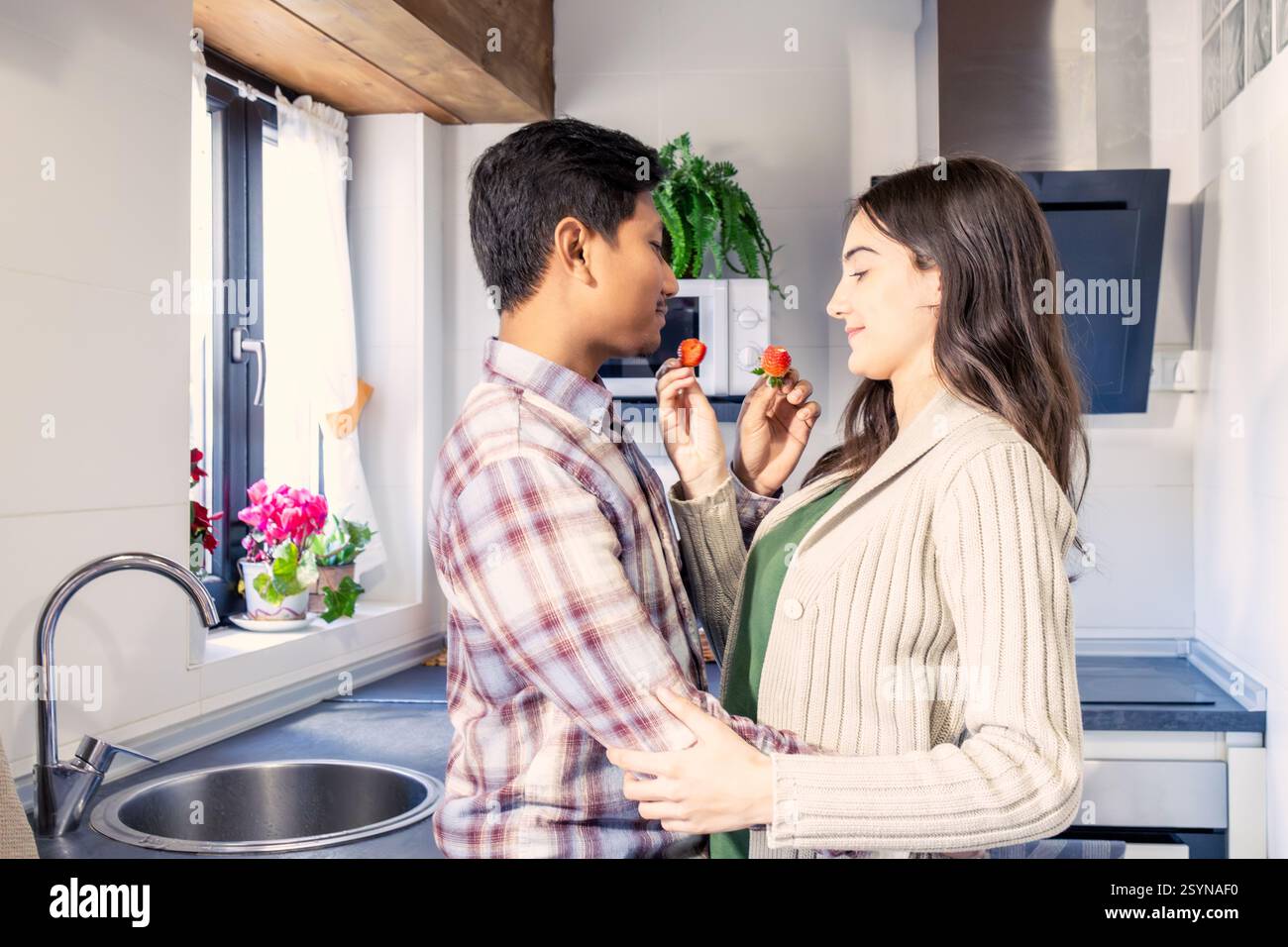 Loving couple enjoying a playful and intimate moment while holding ...