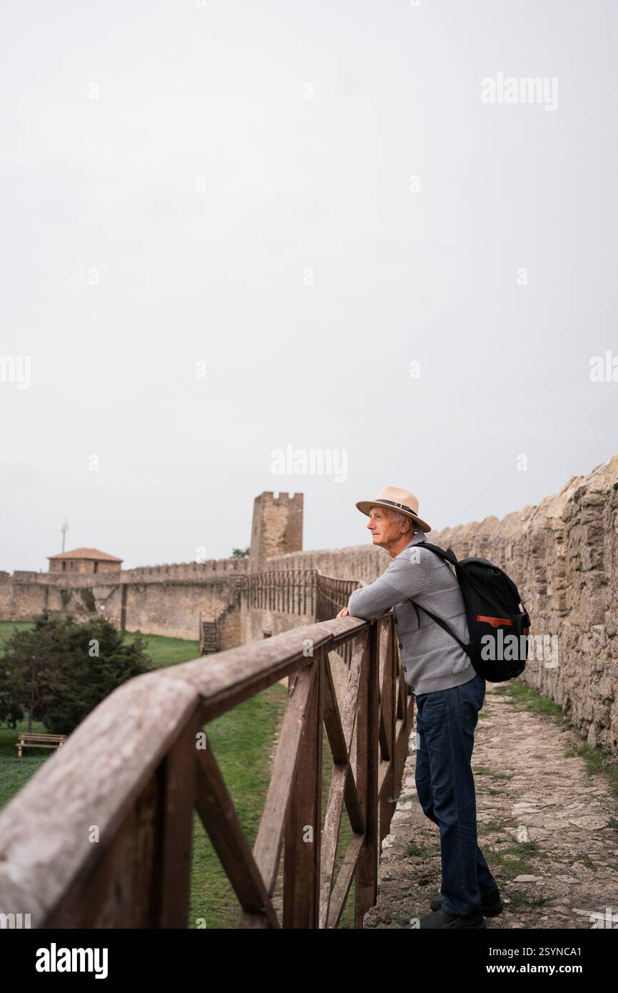 A retired man enjoys the views from the wall of an ancient medieval ...