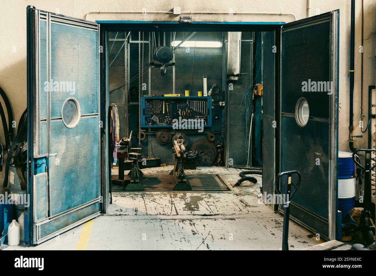 Large blue industrial doors open to reveal an interior space with ...