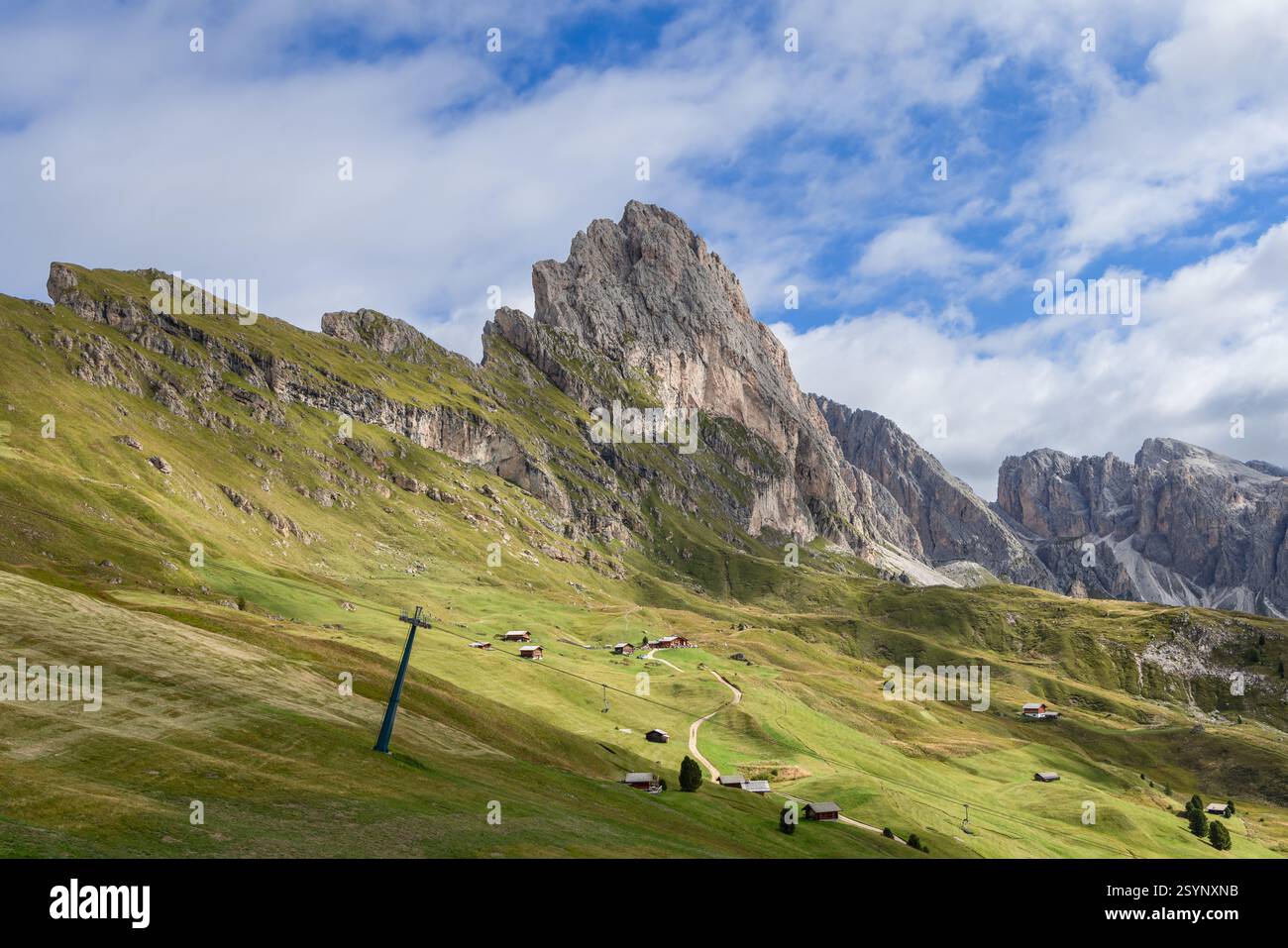 Steep cliffs of Seceda rise dramatically above lush meadows featuring ...