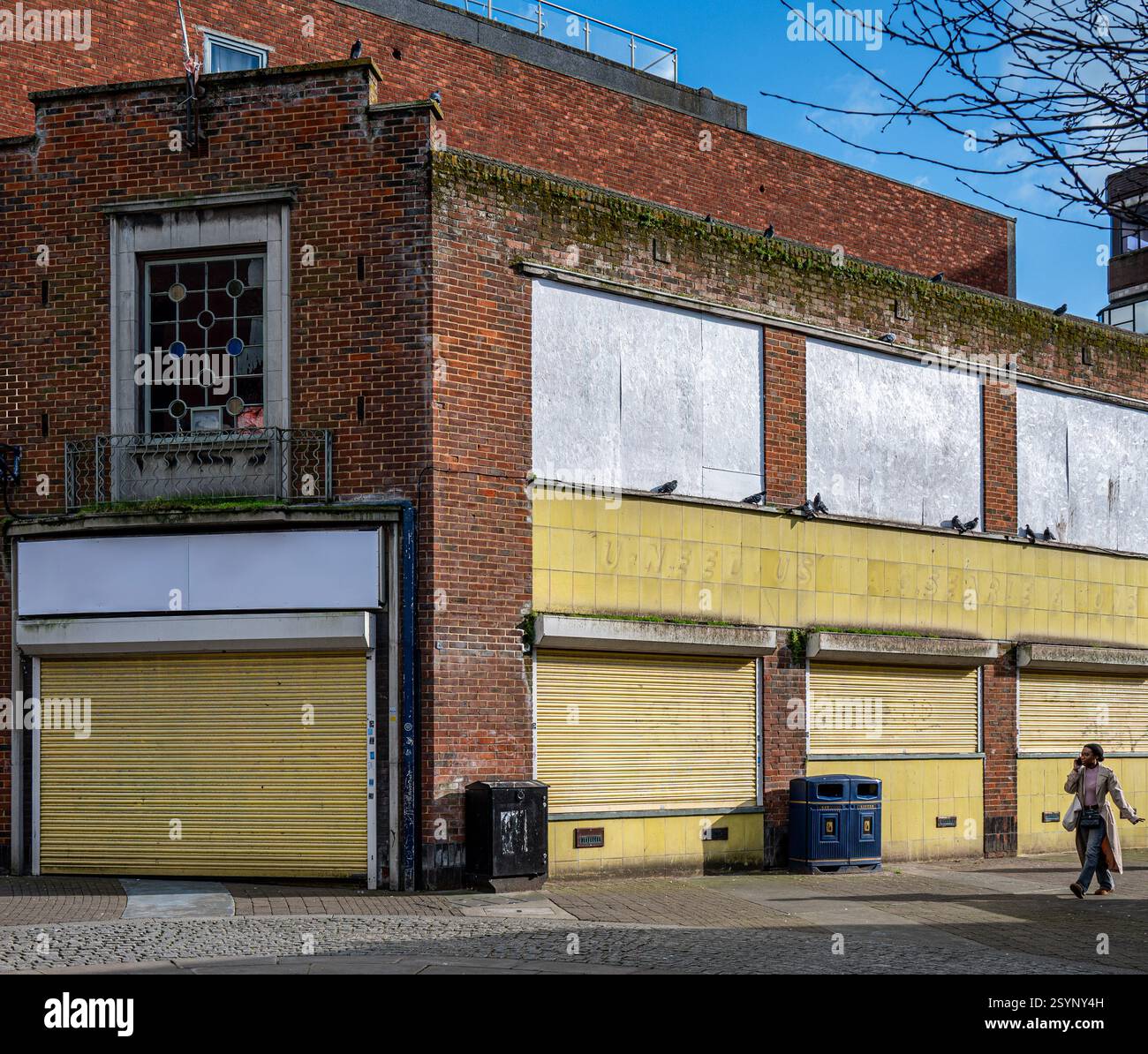 Closed and empty shops in a rundown shopping street in a major UK city ...