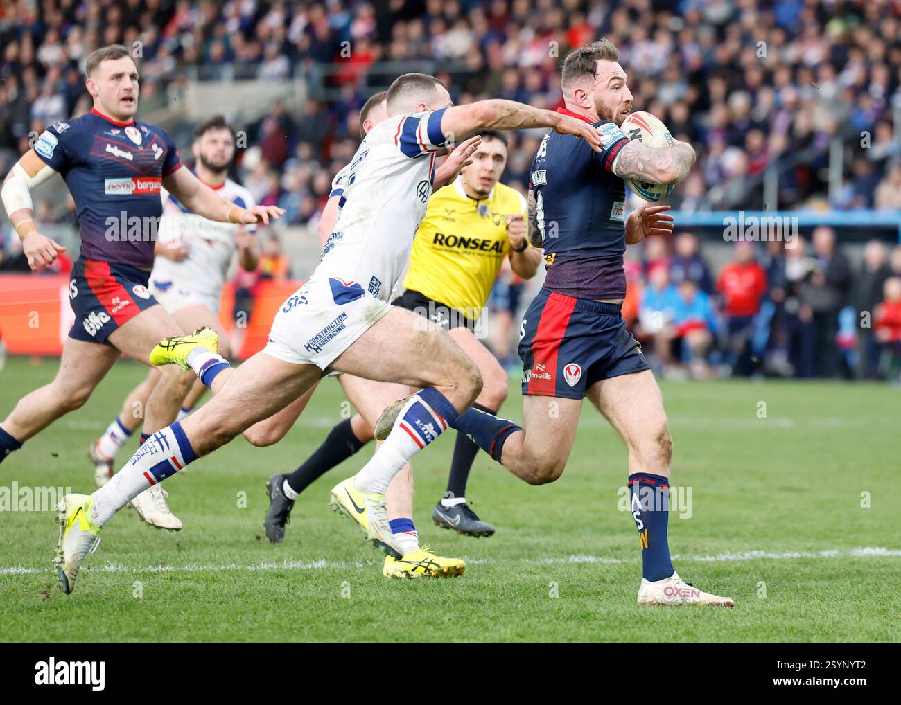 St Helens' Daryl Clark bursts through to score his try during the ...