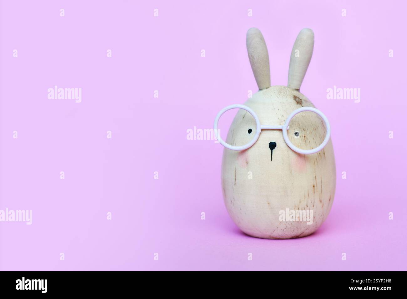 Cute funny egg shaped Easter bunny with glasses on pink background with ...
