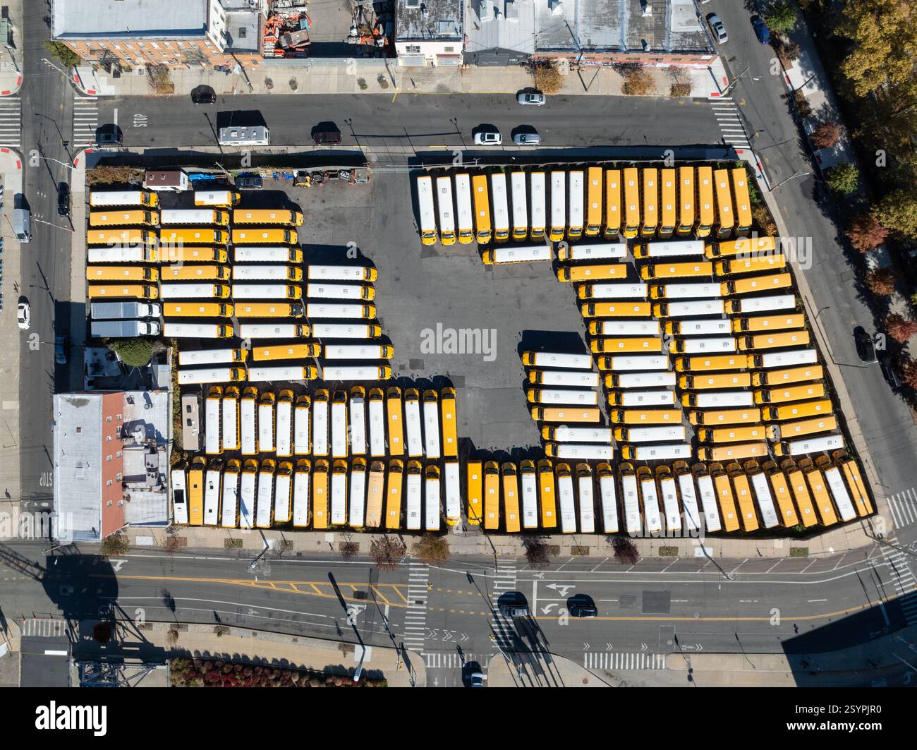 Yellow School Buses aerial top view in a parking lot, side by side ...
