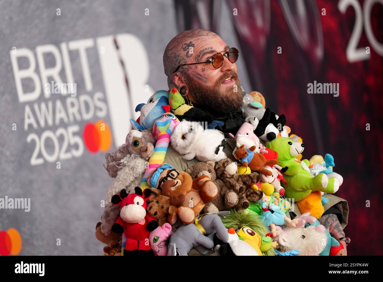 Teddy Swims poses for photographers upon arrival at the Brit Awards ...