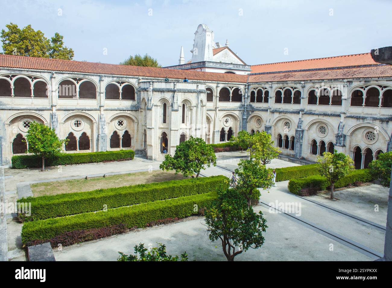 serene courtyard within a historic monastery, featuring a symmetrical ...