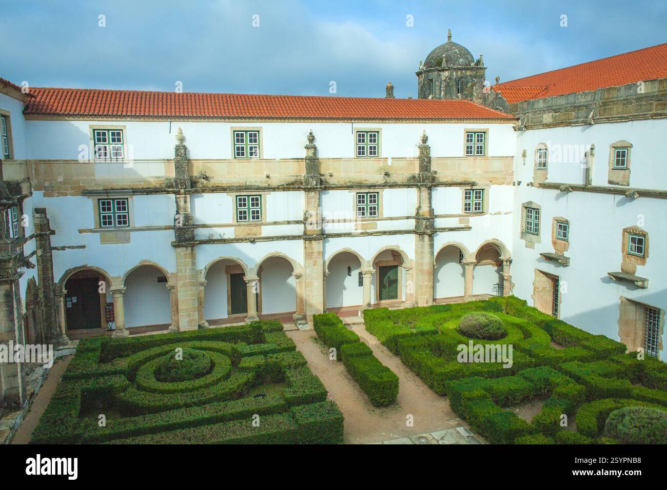 courtyard within a historic monastery, featuring a symmetrical layout ...