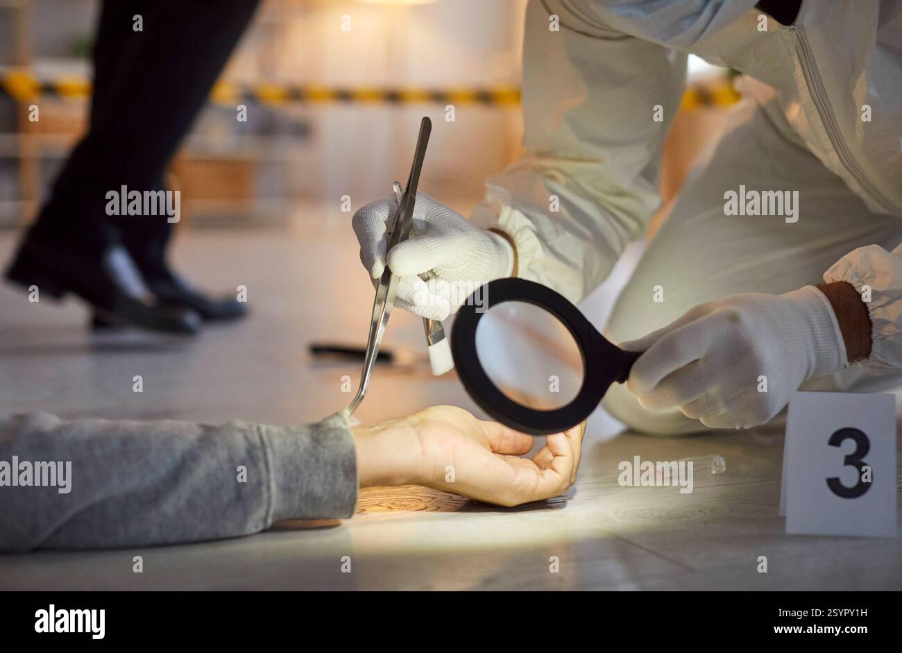 Forensic investigator analyzing evidence on dead victim body with ...
