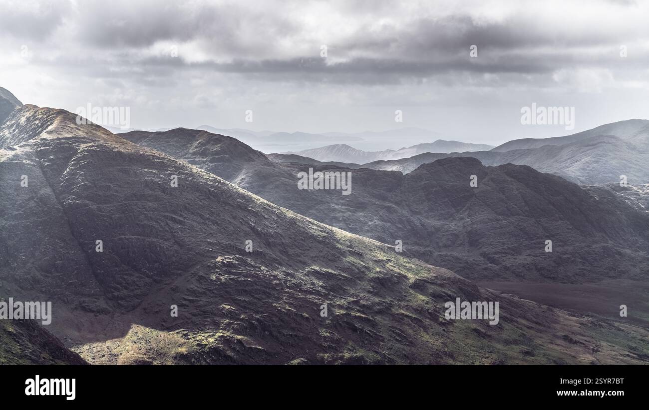 Breathtaking view of expansive mountain ranges shrouded in atmospheric ...
