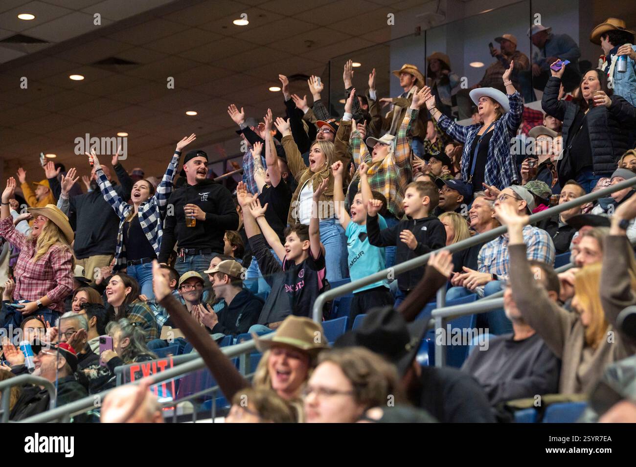 Audience members dance during the Professional Bull Riders (PBR ...