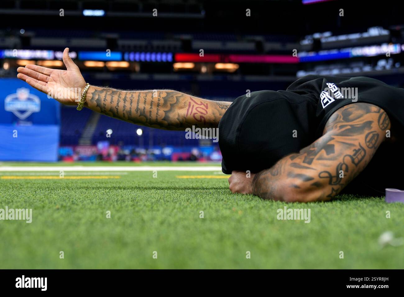 Miami tight end Elijah Arroyo stretches at the NFL football scouting ...
