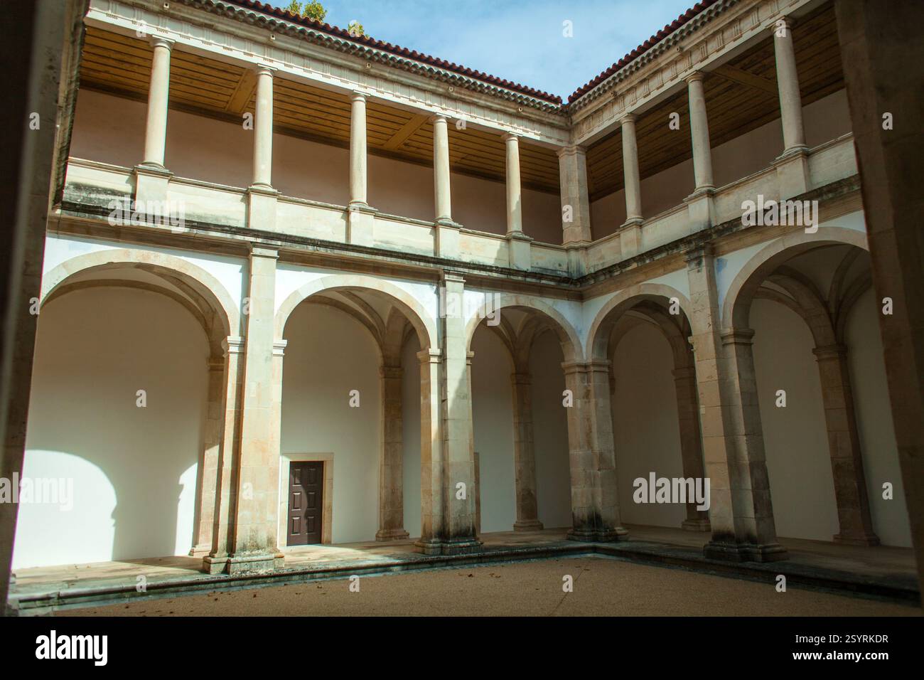 a peaceful cloister courtyard with a series of stone arches supported ...