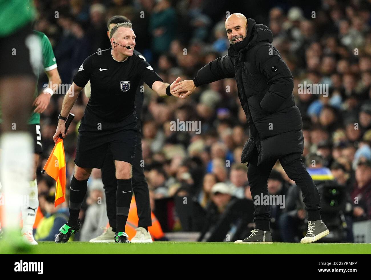 Manchester City manager Pep Guardiola (right) shakes the hand with the ...