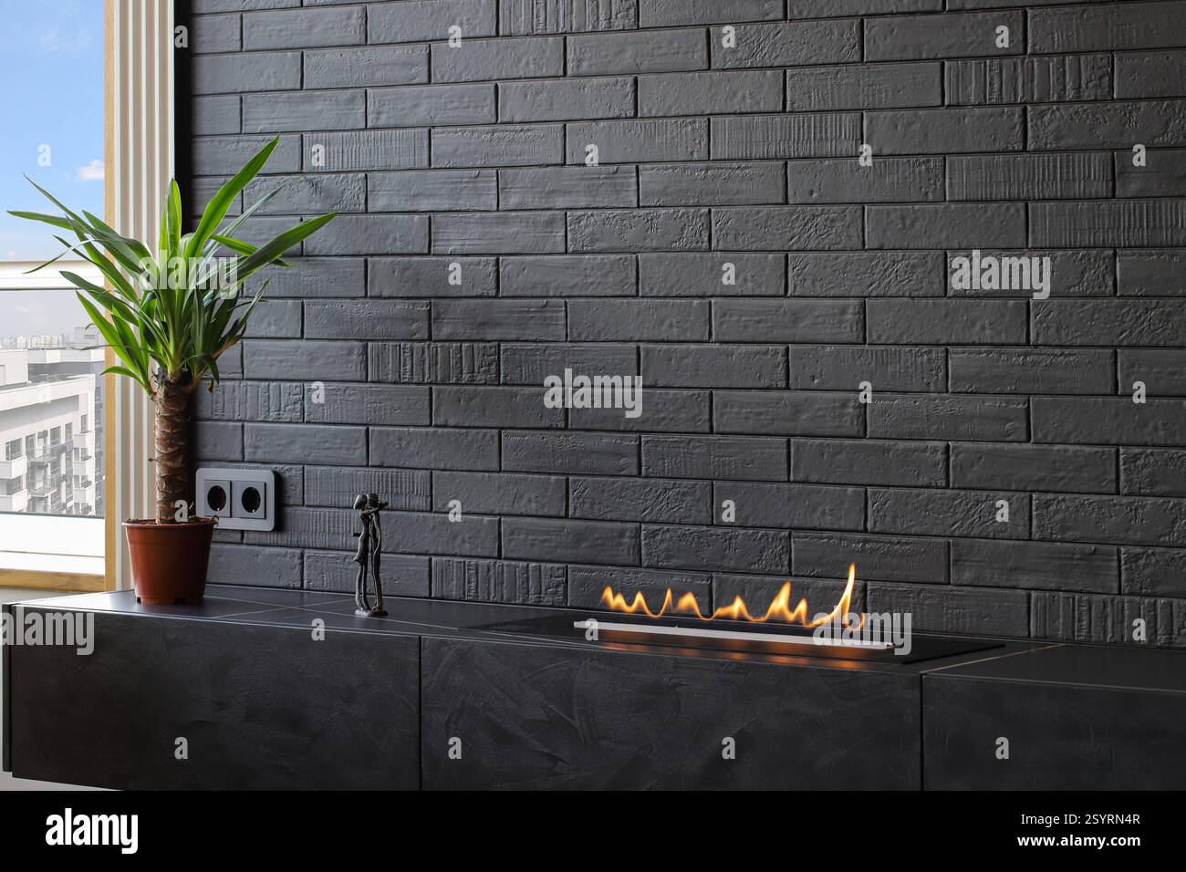 Burning modern eco bio ethanol fireplace built into furniture Stock ...