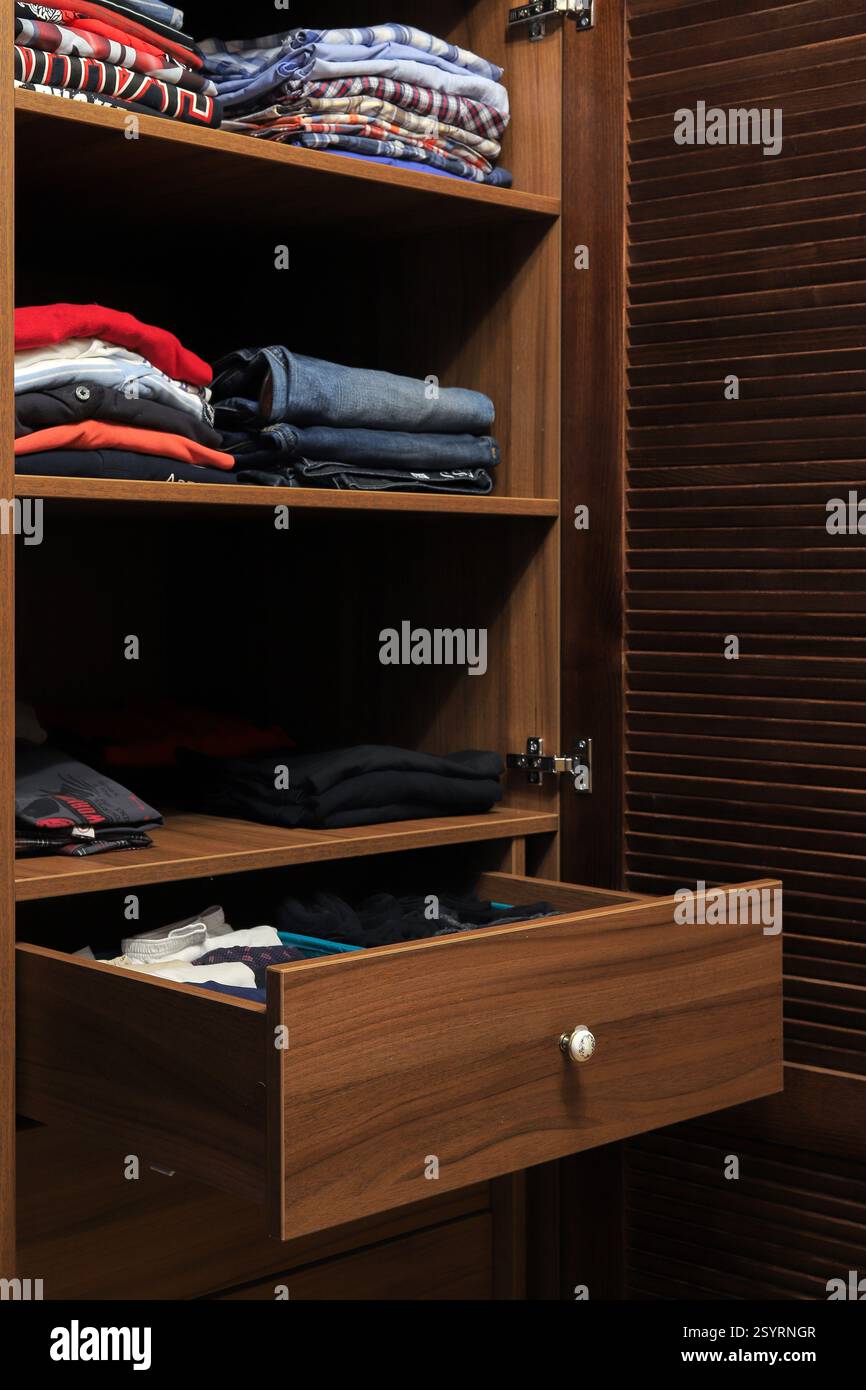 An open drawer in a wardrobe with clothes close-up Stock Photo - Alamy