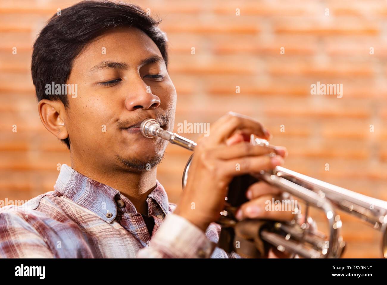 Focused musician playing the trumpet with passion. Lifestyle Stock ...