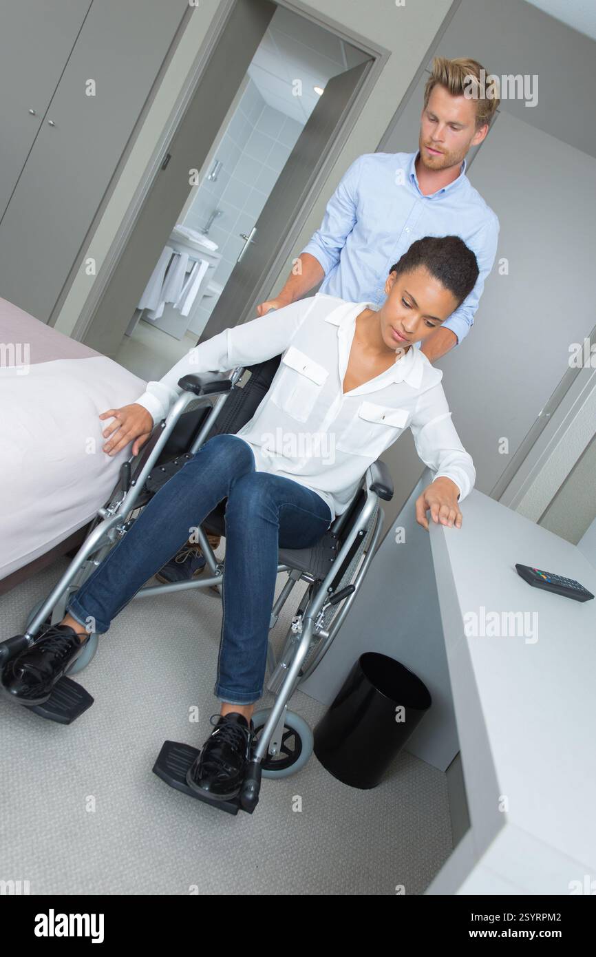 woman in wheelchair pushed in a hotel Stock Photo - Alamy