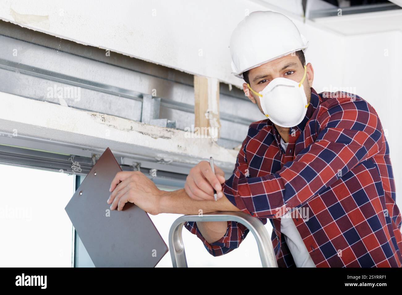 male worker wearing mask writing notes Stock Photo - Alamy