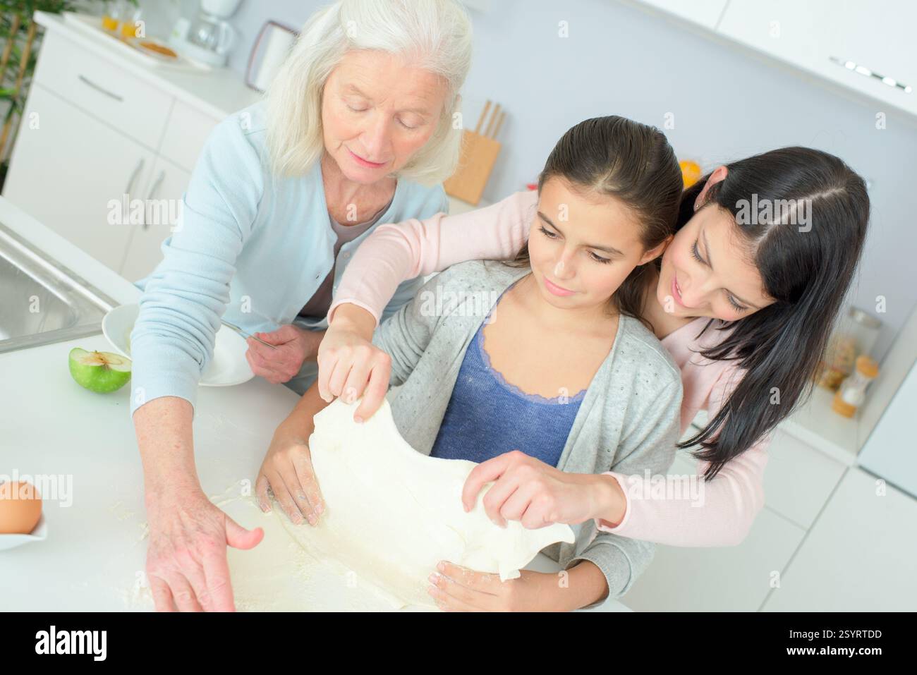 three generations making cooking together Stock Photo - Alamy