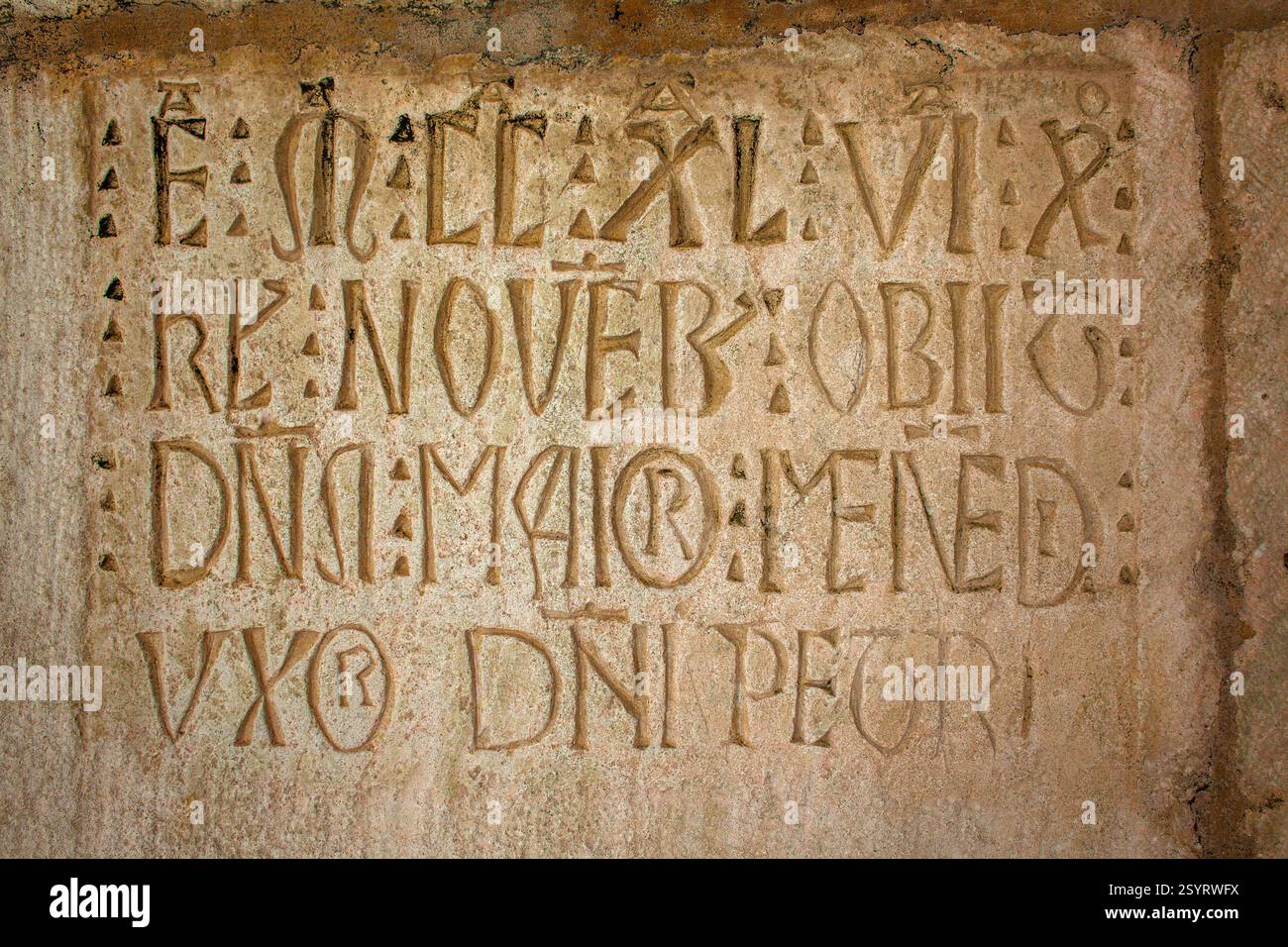 a close-up of an ancient stone inscription with intricate lettering ...