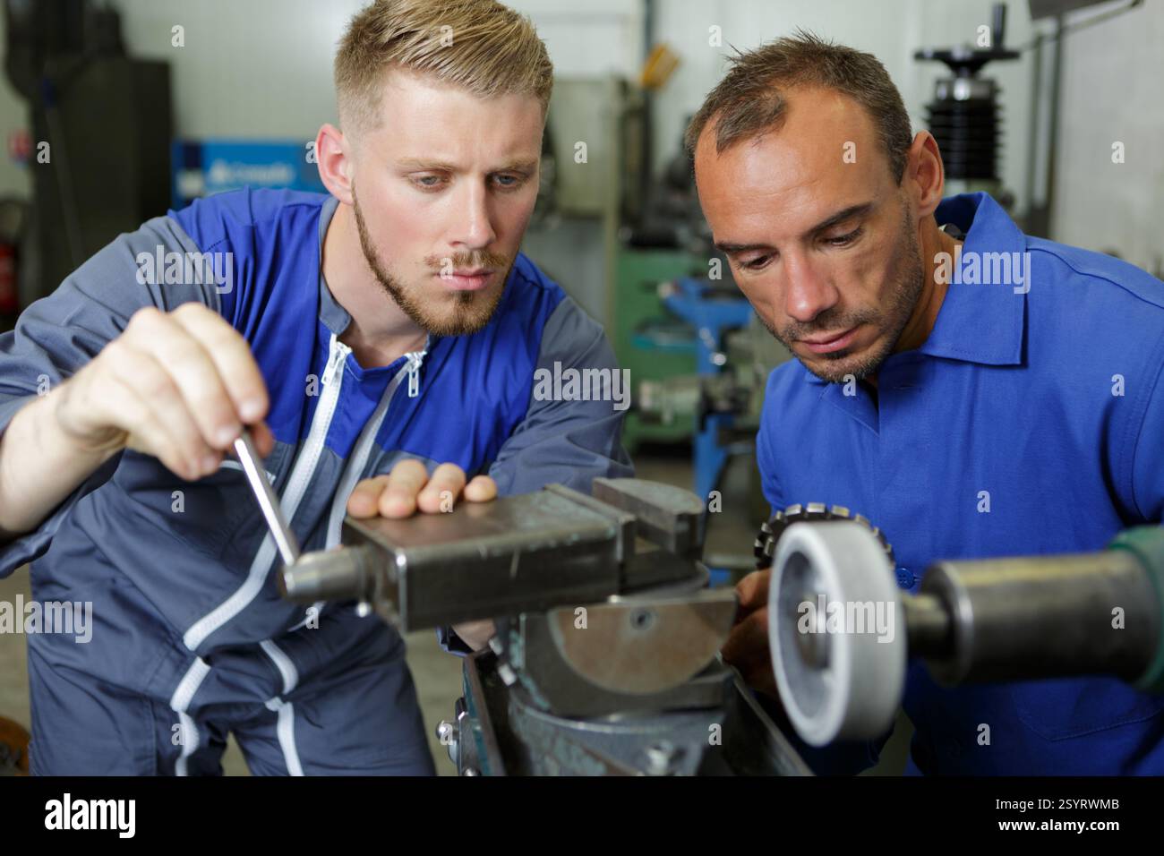 metal lathe maintenance people at work Stock Photo - Alamy