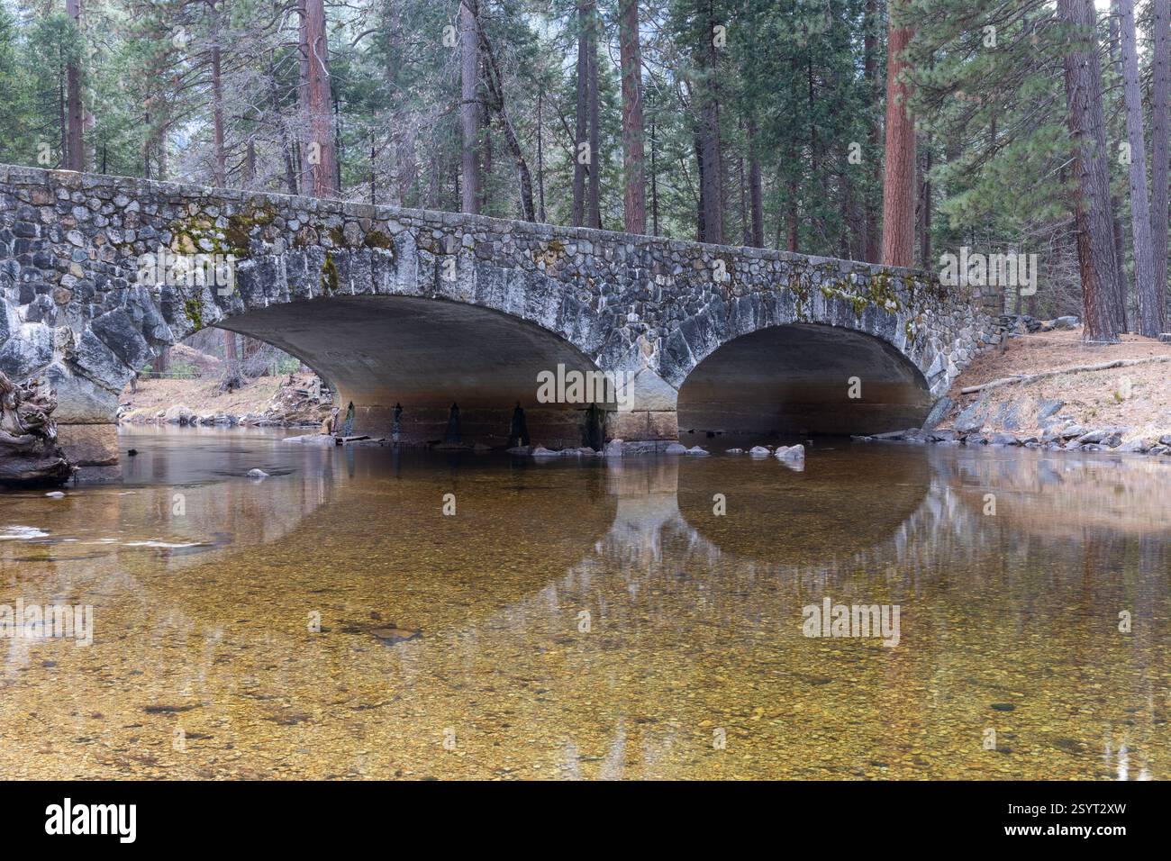 Stone bridge in Yosemite reflected in Merced river Stock Photo - Alamy