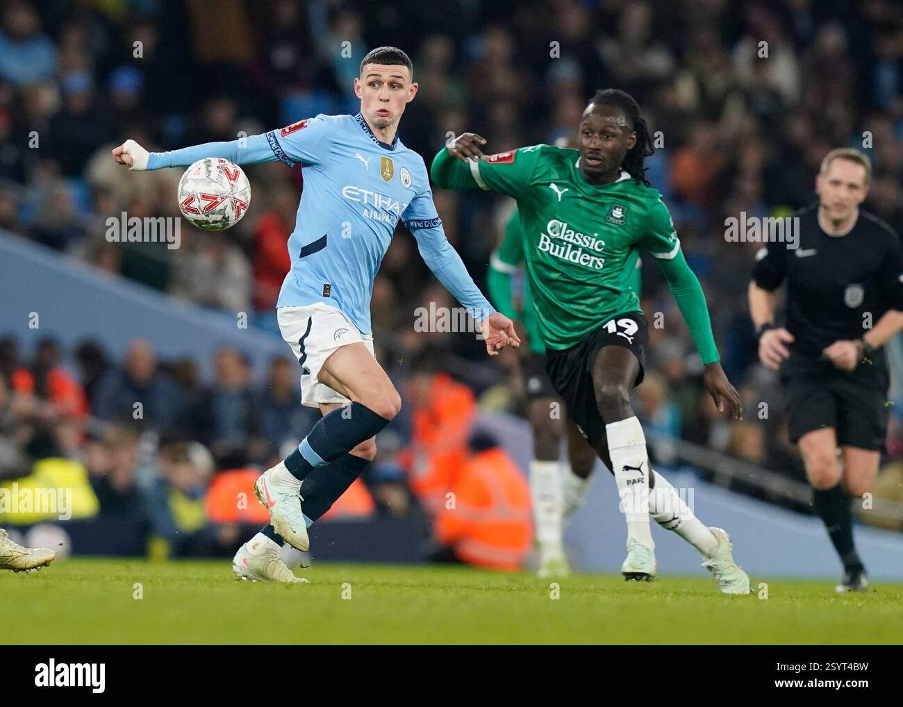 Manchester, UK. 1st Mar, 2025. Phil Foden of Manchester City and Malachi Boateng of Plymouth ...