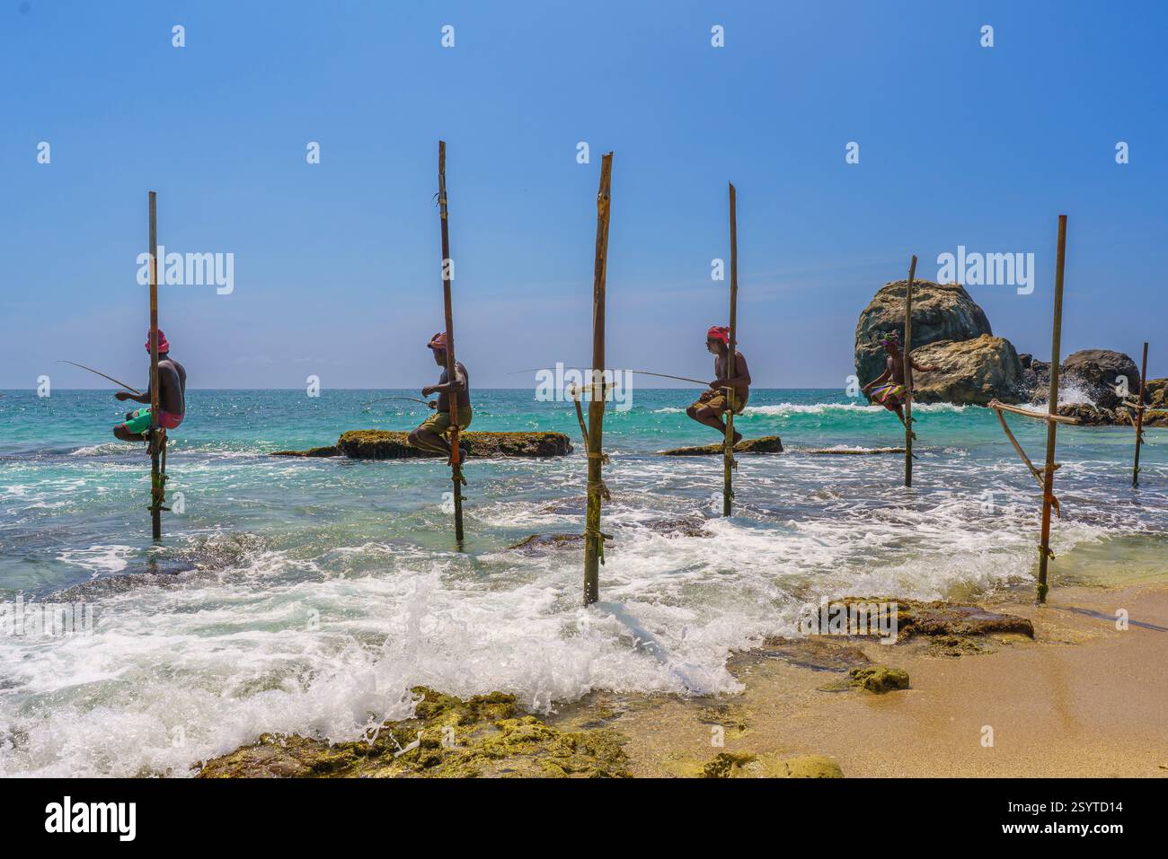 Traditional fishermens fishing on a stick on the coast of Koggala, Sri ...