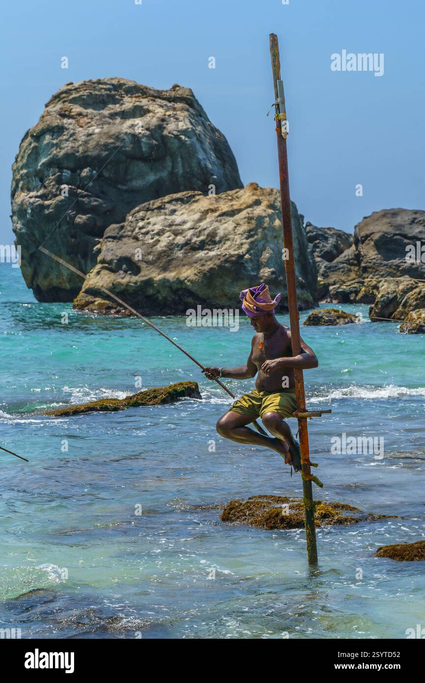 Traditional fishermens fishing on a stick on the coast of Koggala, Sri ...
