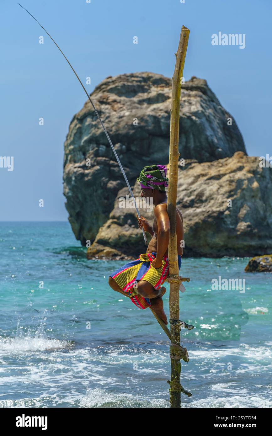 Traditional fishermens fishing on a stick on the coast of Koggala, Sri ...