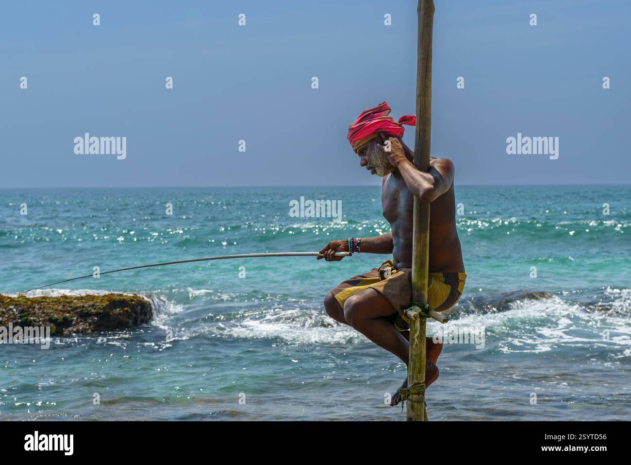 Traditional fishermens fishing on a stick on the coast of Koggala, Sri ...