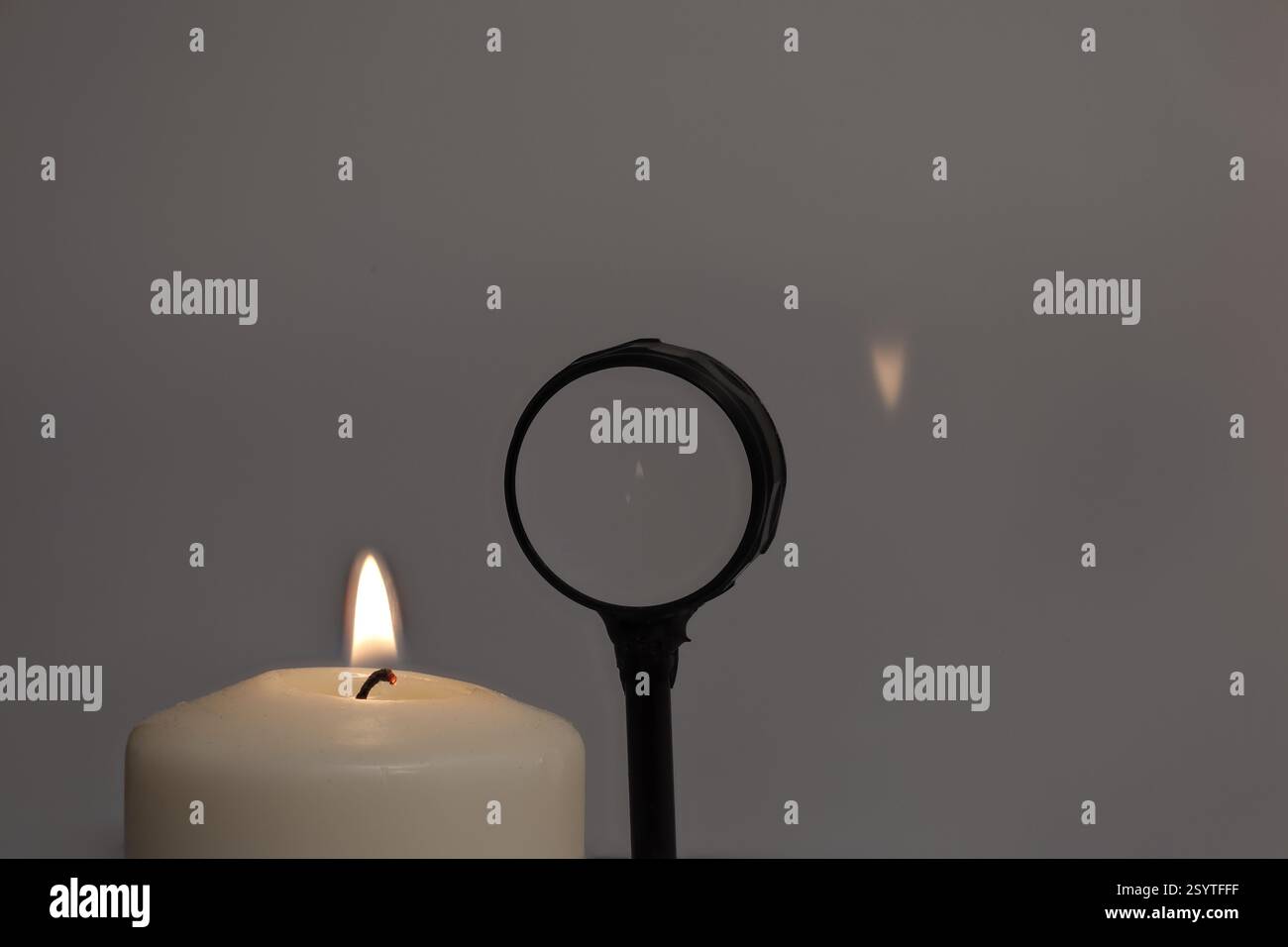 Still life: Experiment with convex lens and candle. Close-up with ...