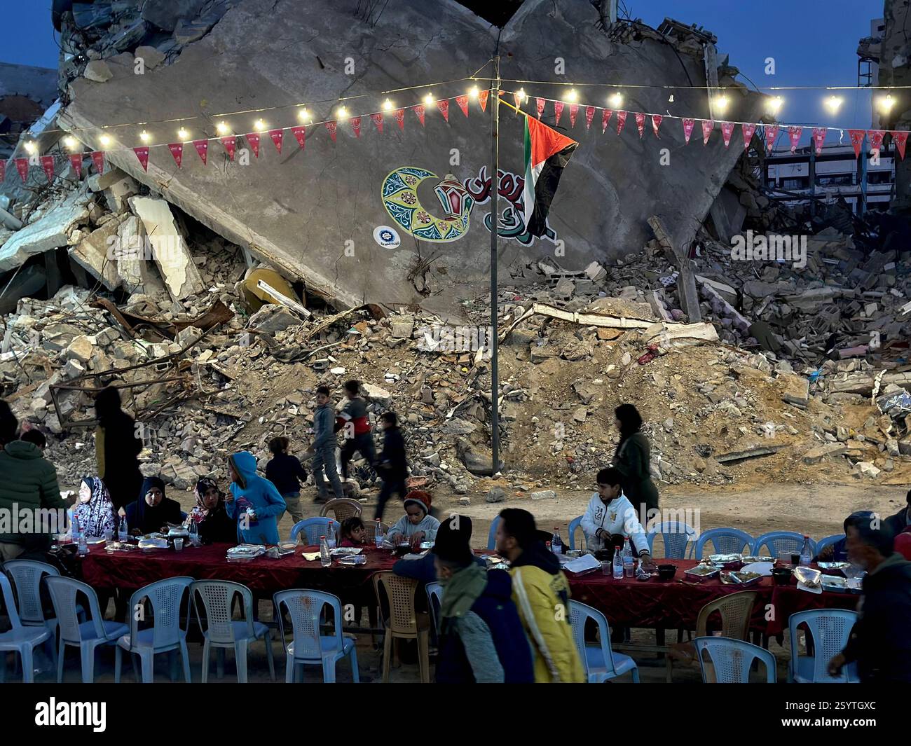 Palestinians break their fast by eating the Iftar meals during the holy ...
