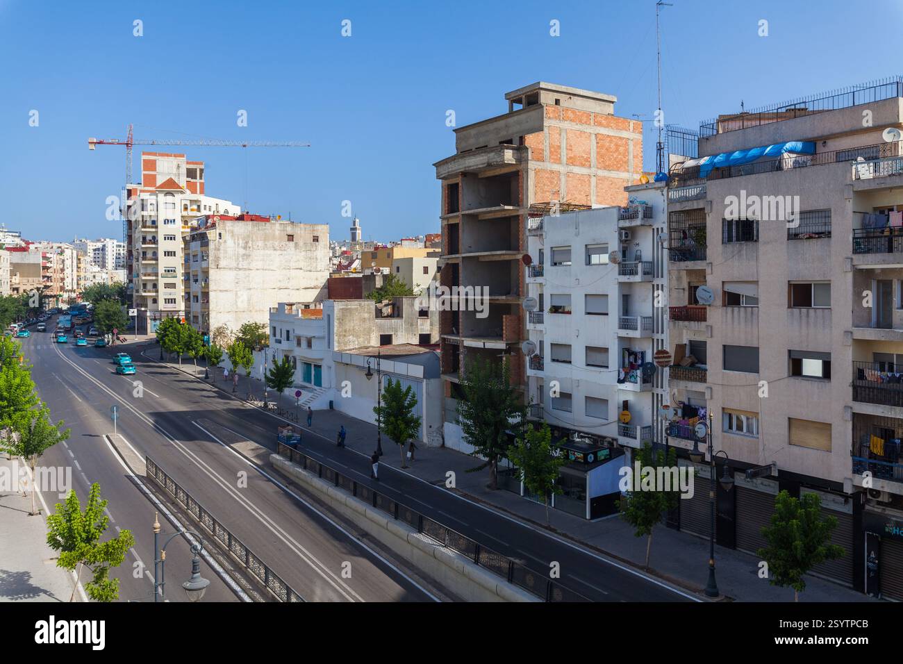 wide, tree-lined avenue cutting through a densely populated ...