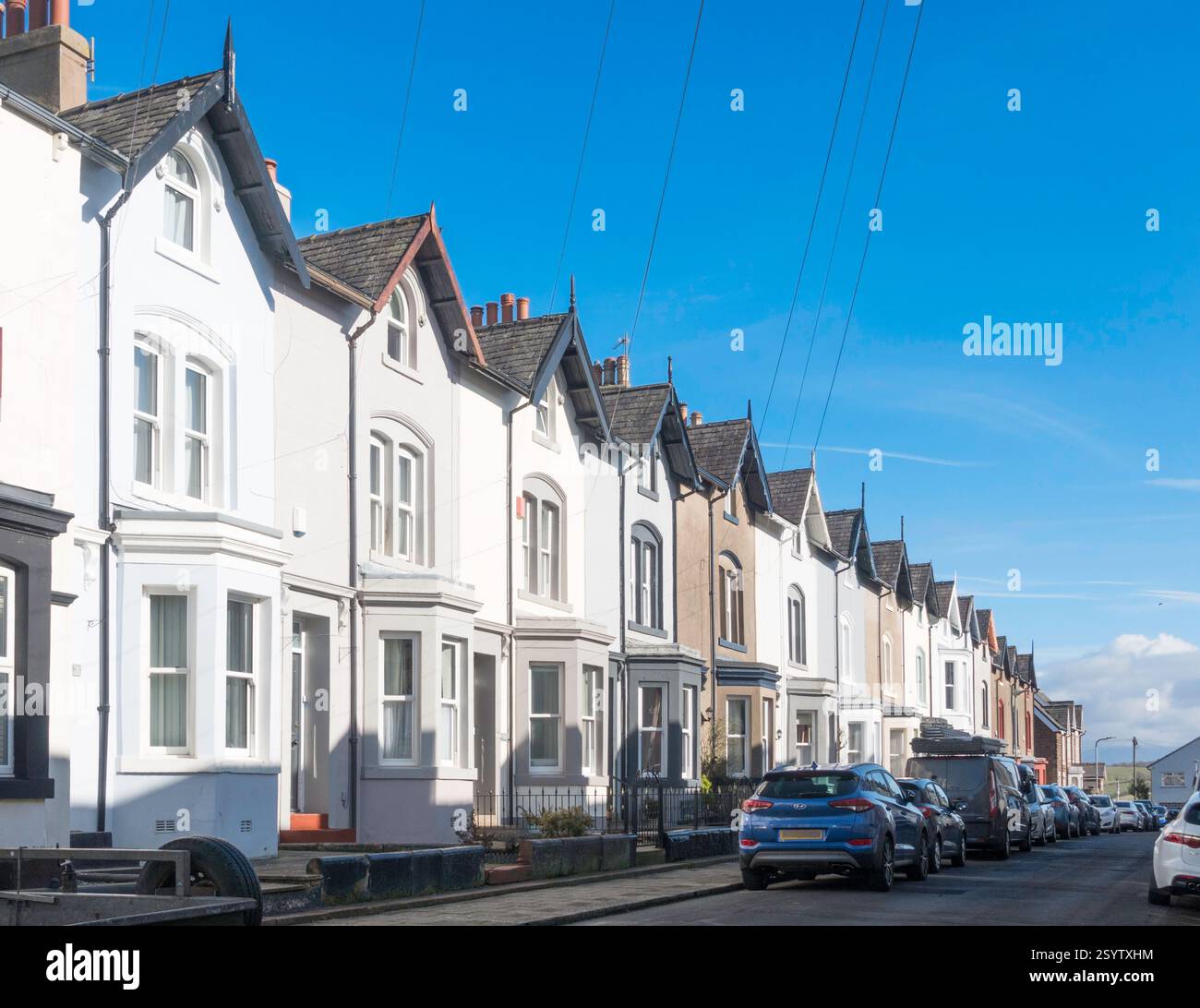 A terrace of gable fronted three storey painted houses in North Street ...
