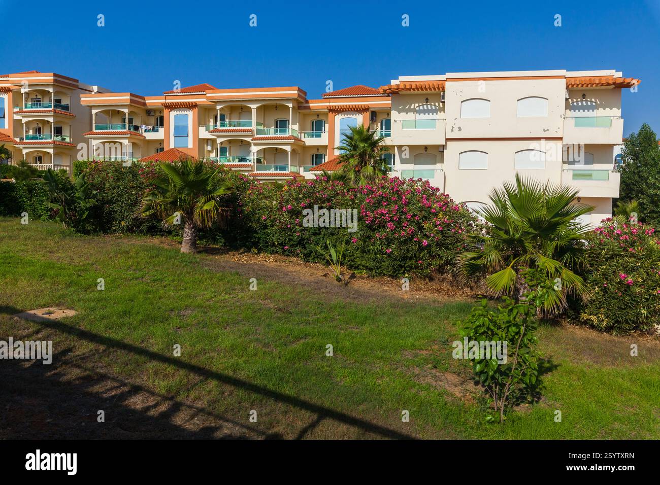 Mediterranean-style apartment complex with colorful facades, balconies ...