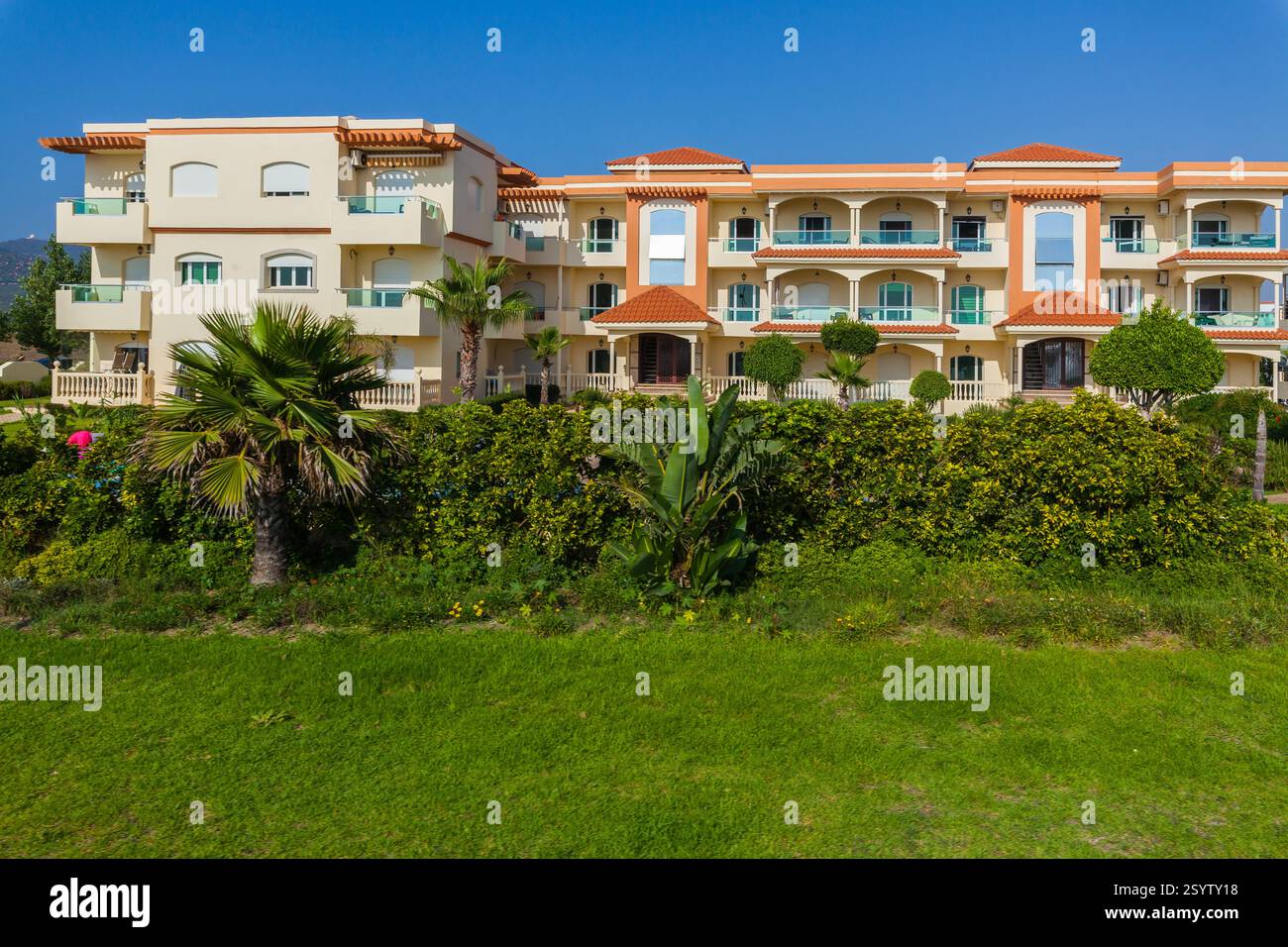 Mediterranean-style apartment complex with colorful facades, balconies ...