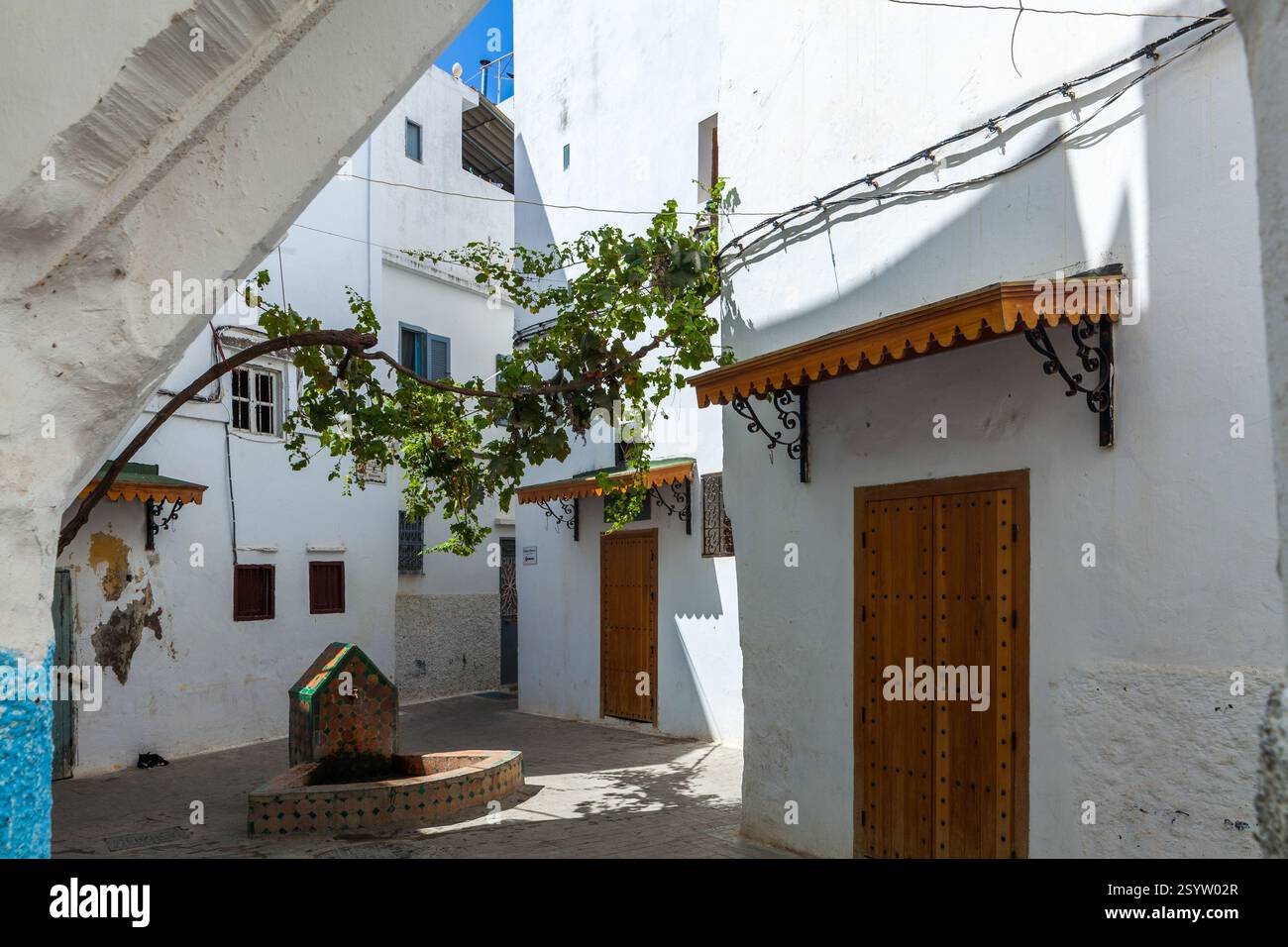 tranquil courtyard scene in a Mediterranean town, with whitewashed ...