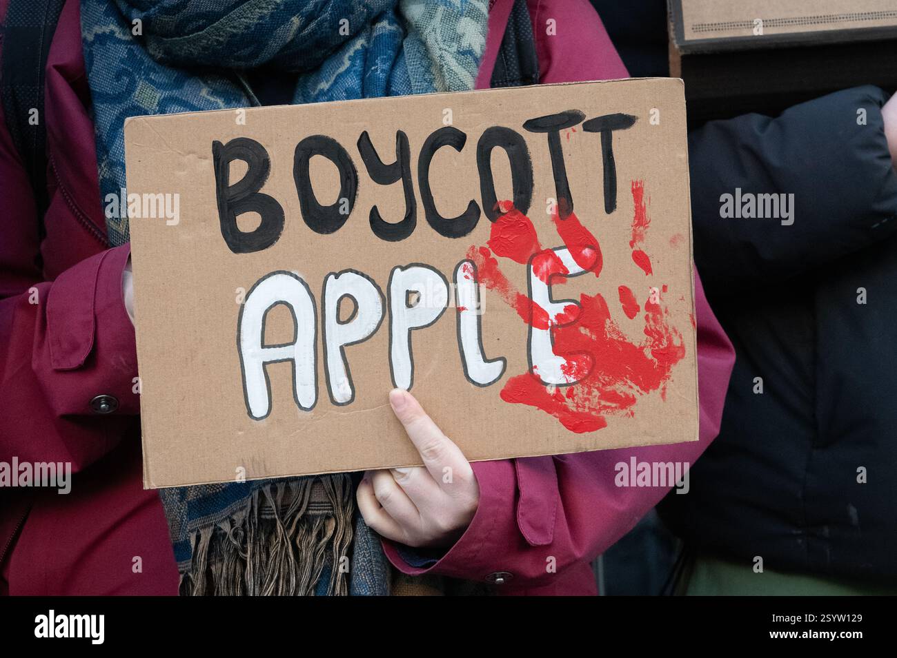 London, UK. 1 March, 2025. A "Boycott Apple" placard with a bloody hand ...