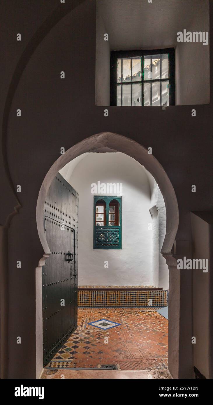 dimly lit interior space with a series of arched doorways leading to a ...