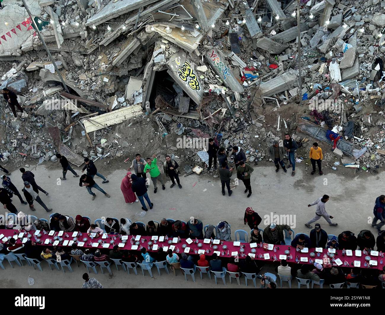 Palestinians break their fast by eating the Iftar meals during the holy ...