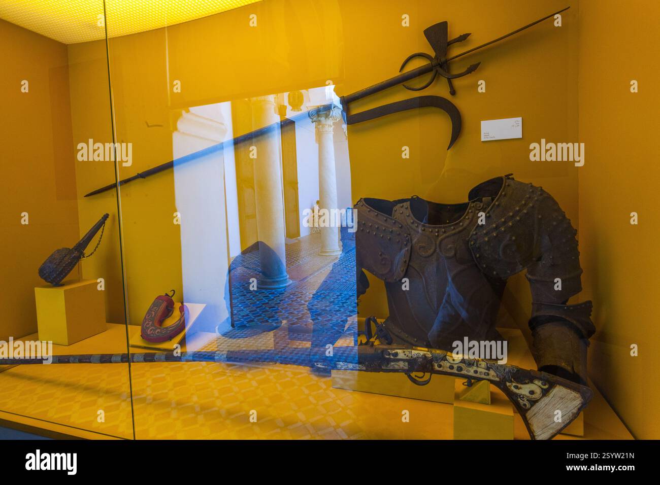 museum display case showcasing a collection of medieval weaponry ...