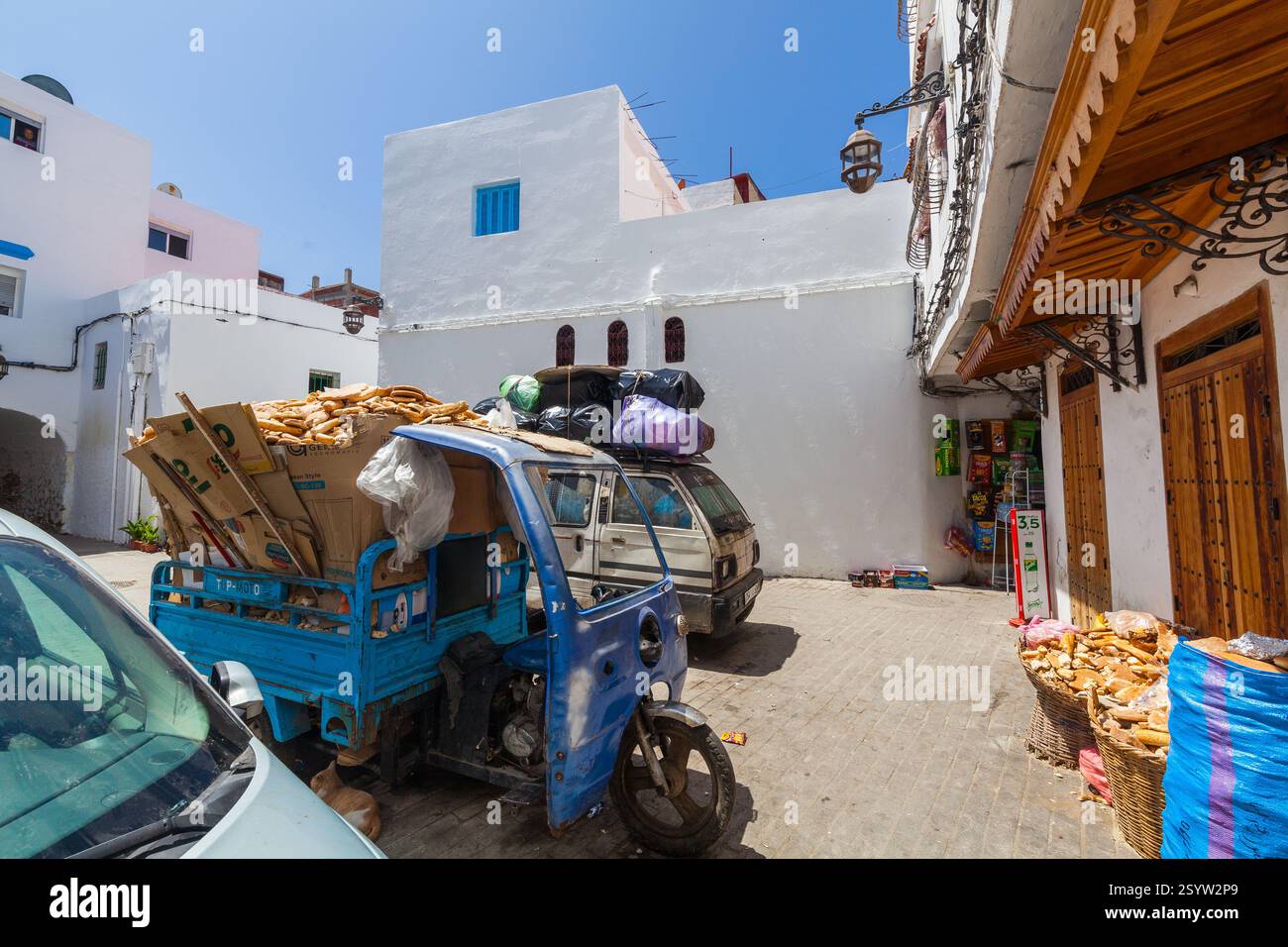 bustling street scene in a Mediterranean town, featuring whitewashed ...