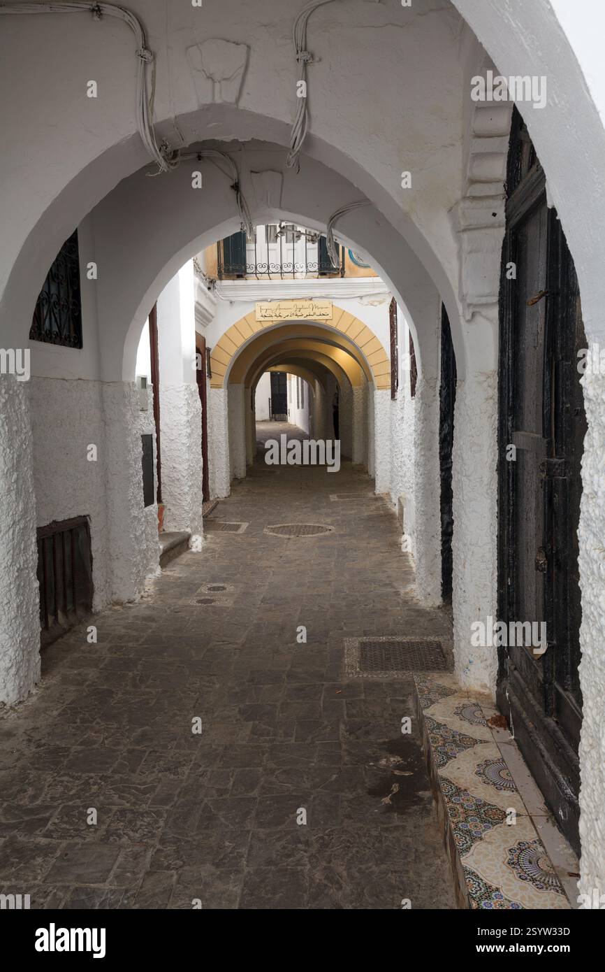 passageway with a series of arches and whitewashed walls, creating a ...