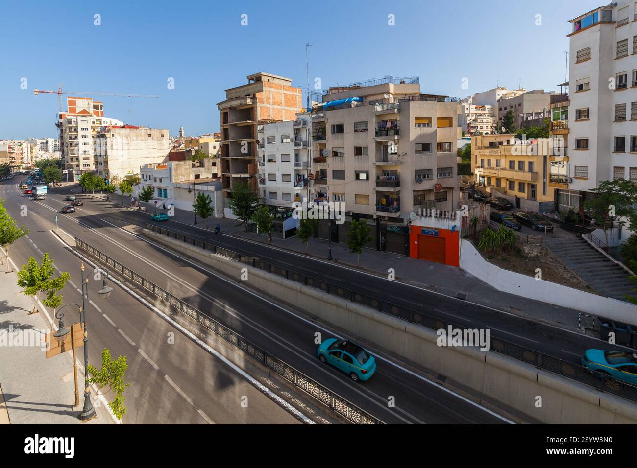 wide, tree-lined avenue cutting through a densely populated ...