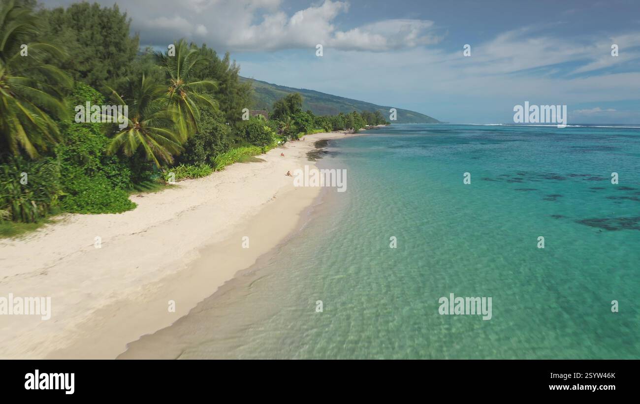 Aerial fly over pristine Tahiti beach with white sand, turquoise coral ...