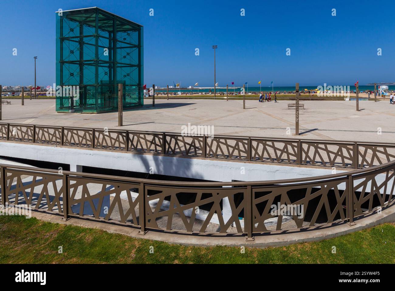 modern coastal promenade with a striking glass structure as a ...